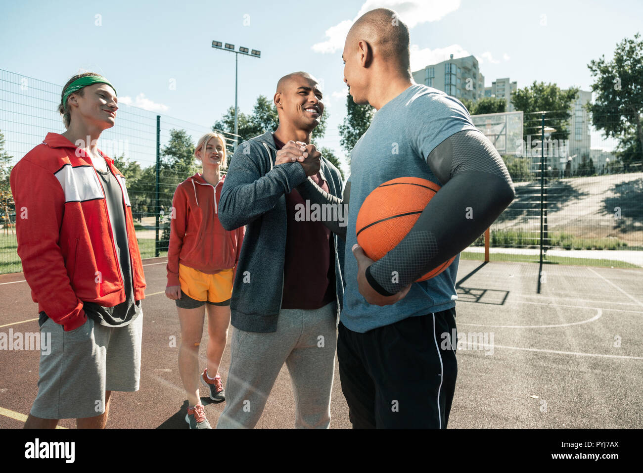 Joyful happy man greeting his basketball coach Stock Photo - Alamy