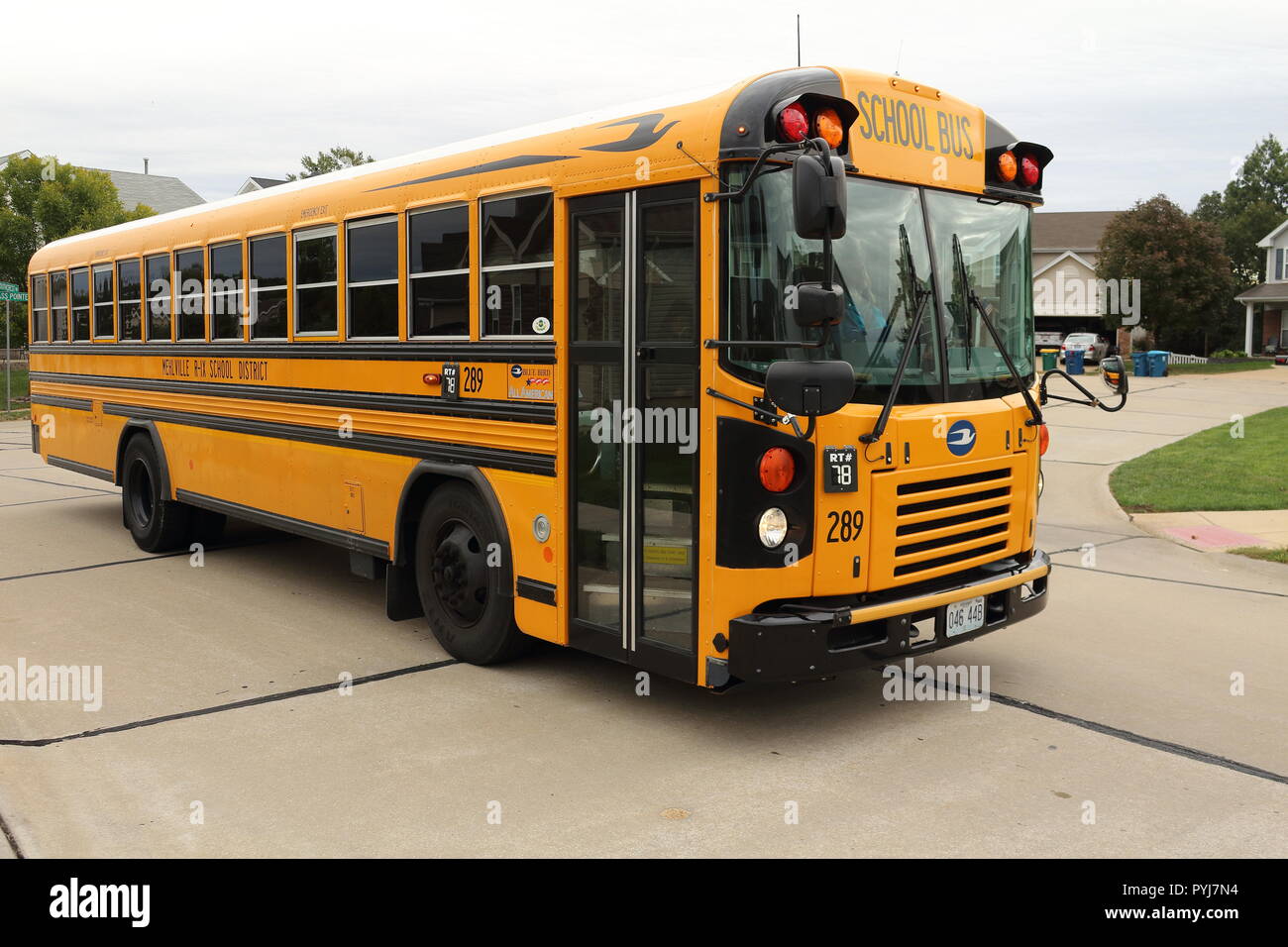 School Bus picking up students in a suburban neighborhood Stock Photo ...
