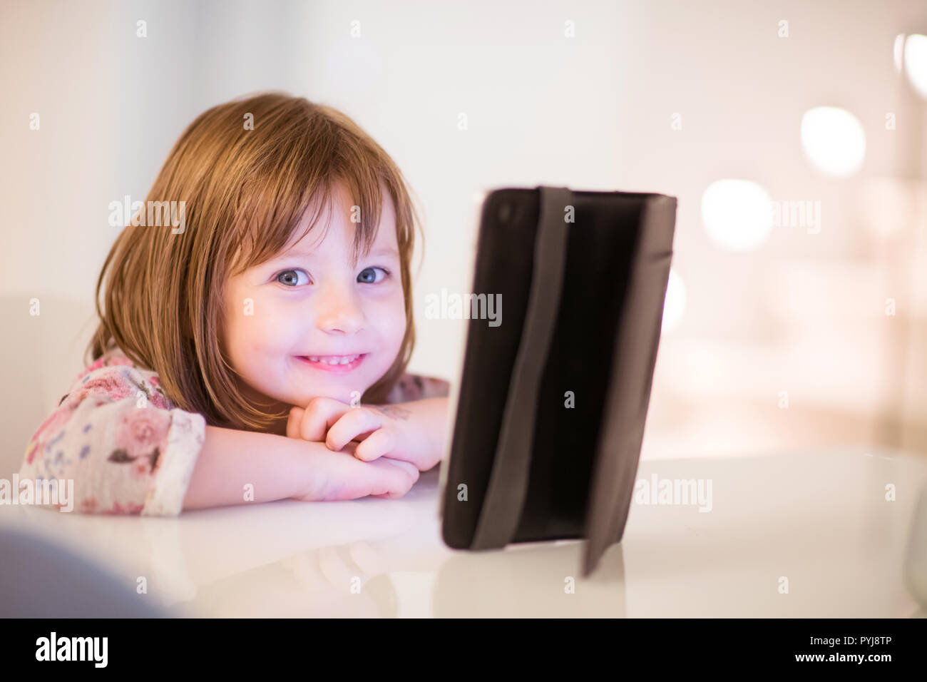 child playing with digital tablet at home Stock Photo - Alamy