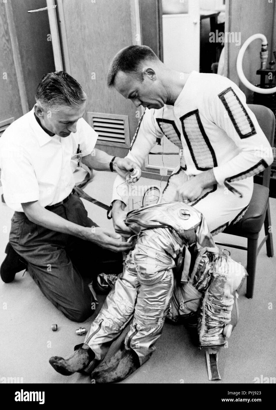 (5 May 1961) --- Astronaut Alan B. Shepard Jr. is being helped into the ...