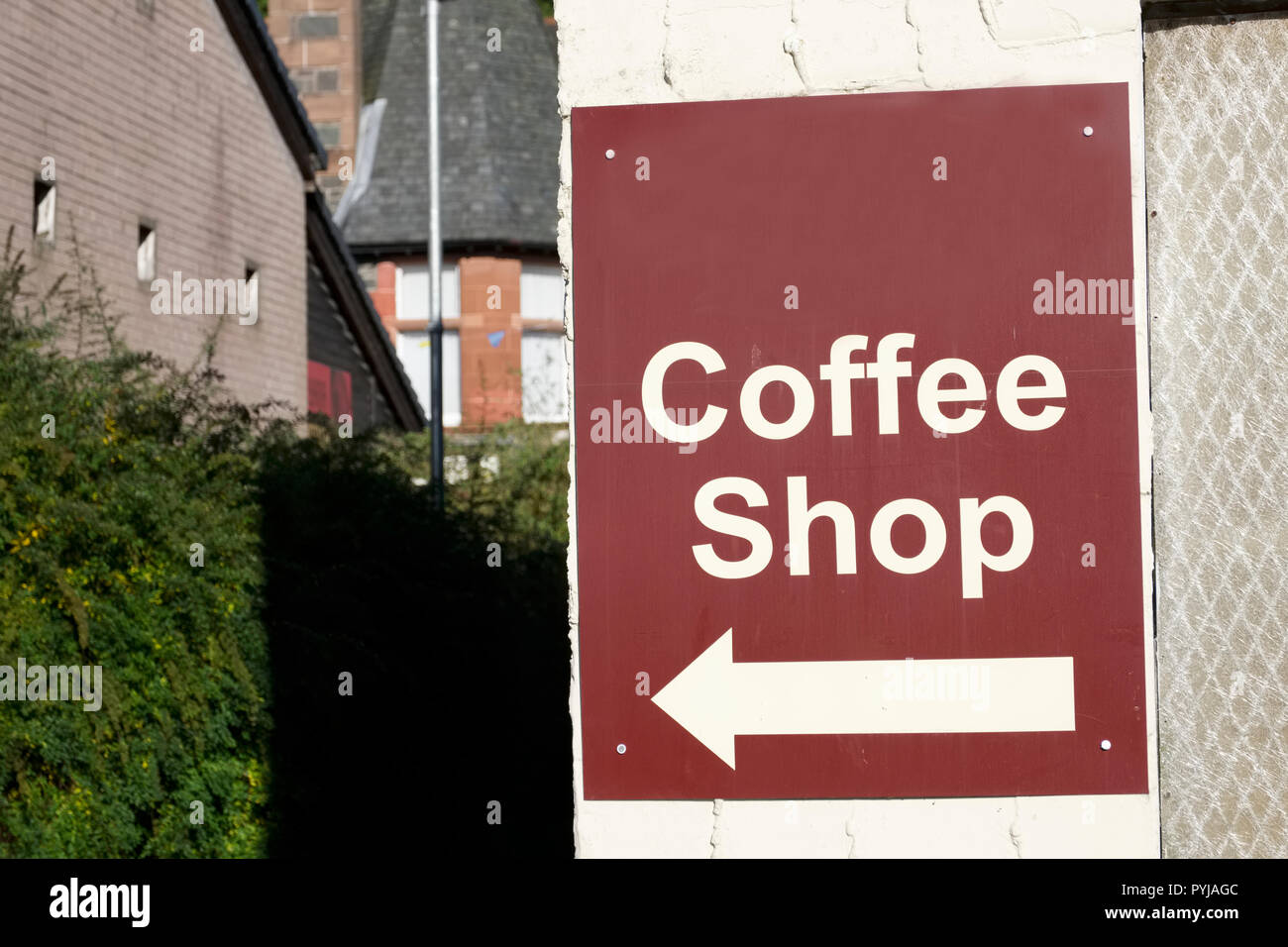 Coffee cafe shop direction arrow sign on wall Stock Photo - Alamy