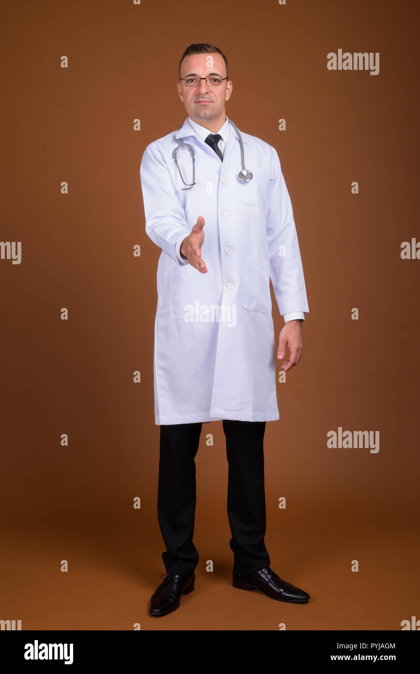 Full length shot of man doctor giving handshake Stock Photo - Alamy