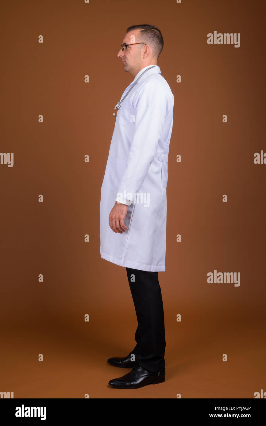 Full length profile view shot of man doctor standing Stock Photo - Alamy