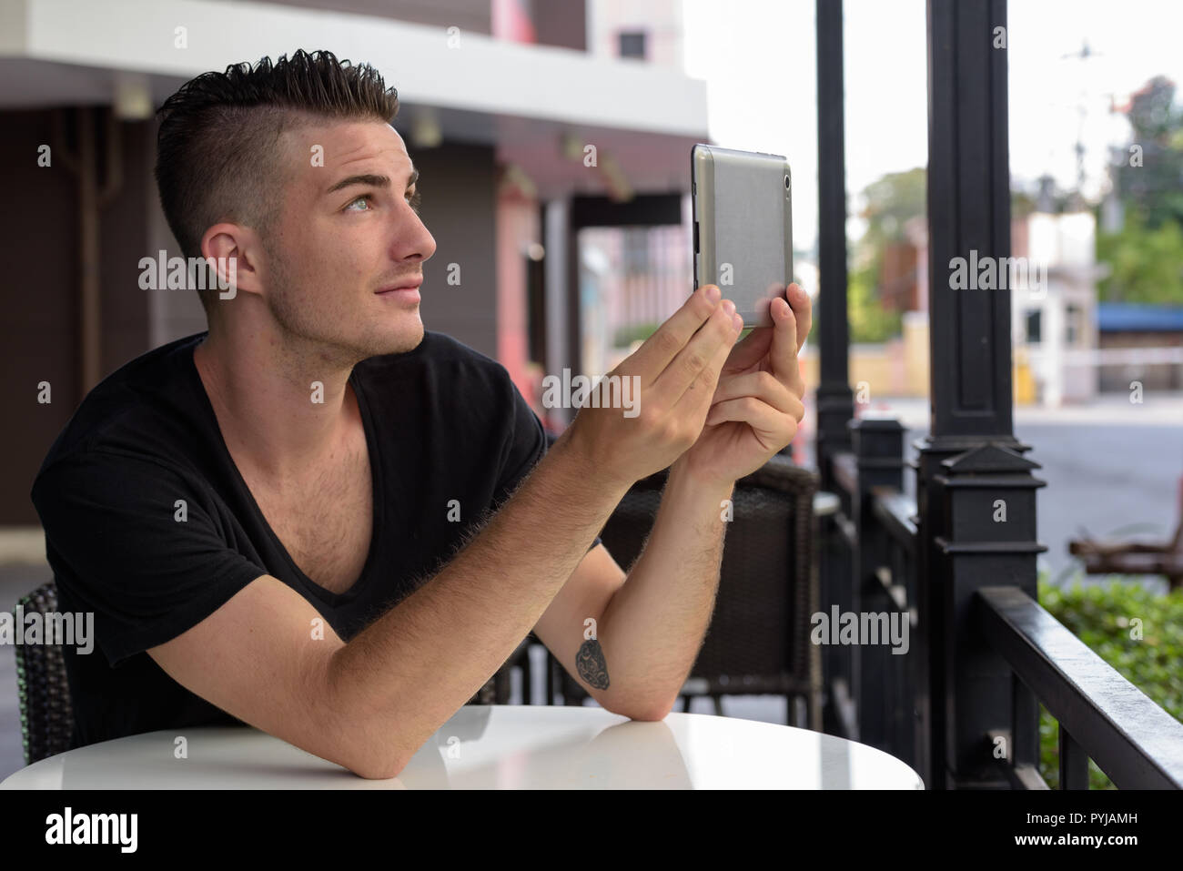 Man smiling holding tablet hi-res stock photography and images - Alamy