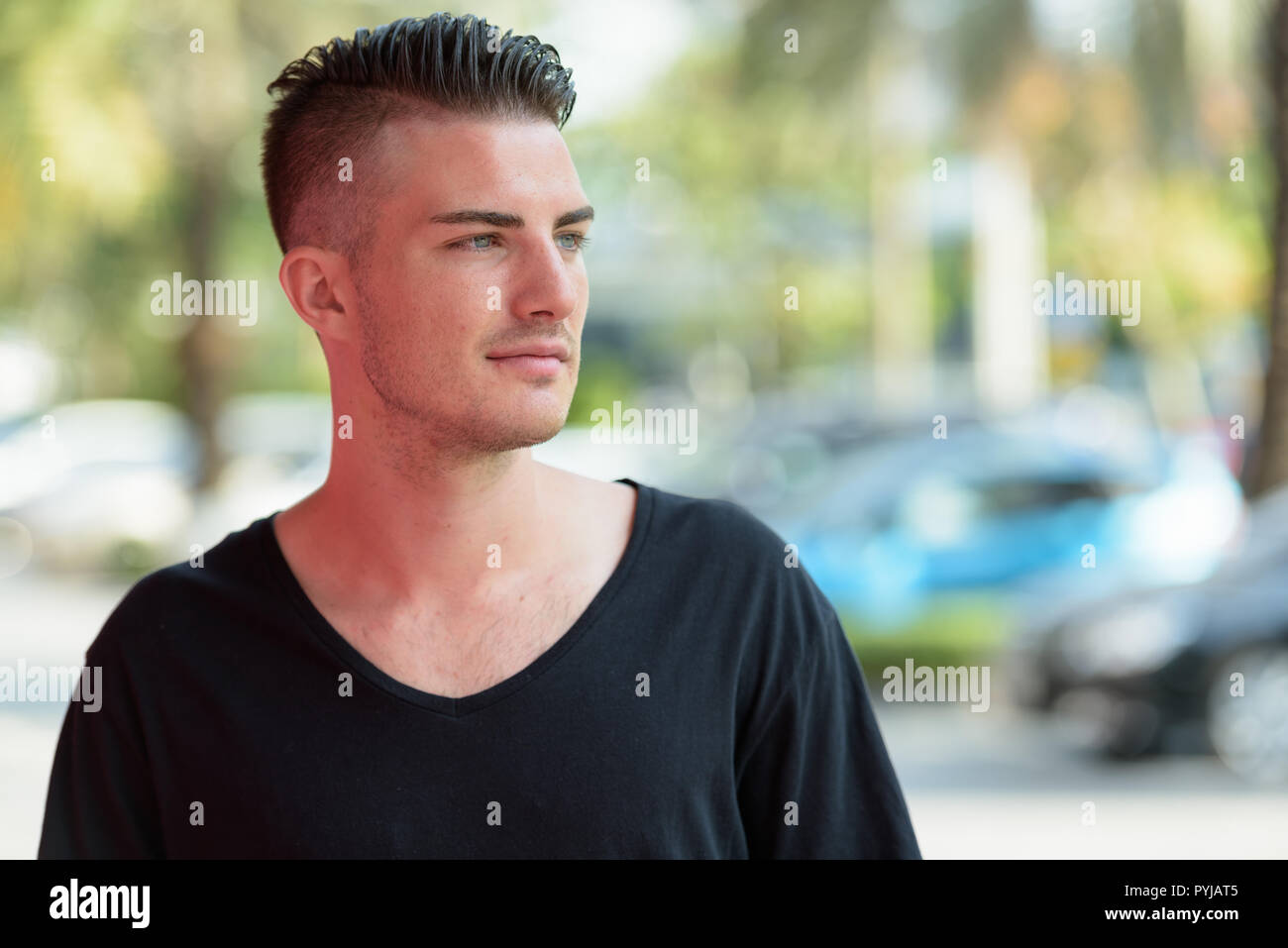 Young handsome man thinking while looking at distance in the par Stock ...