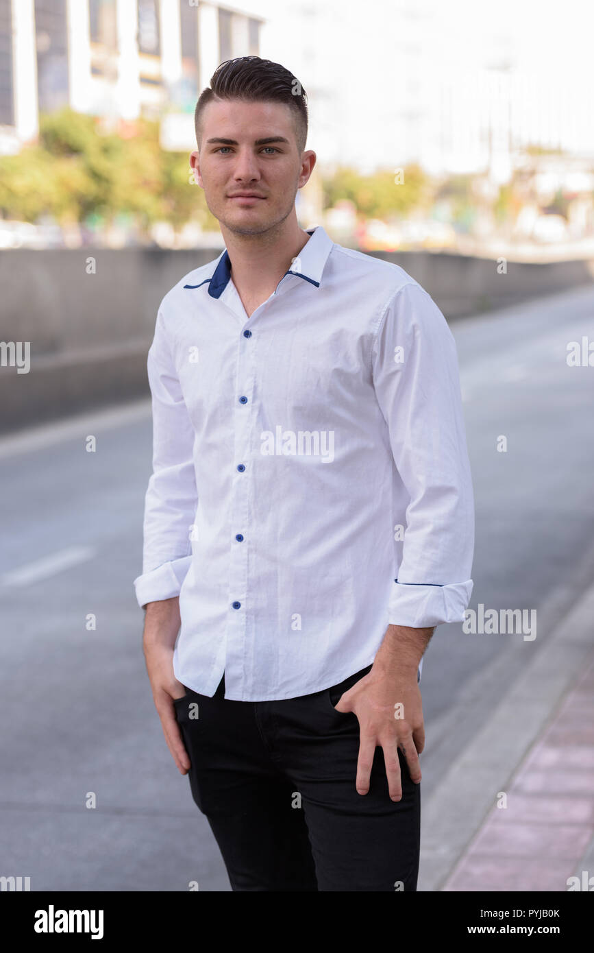 Young handsome man standing and waiting on the side of street Stock ...