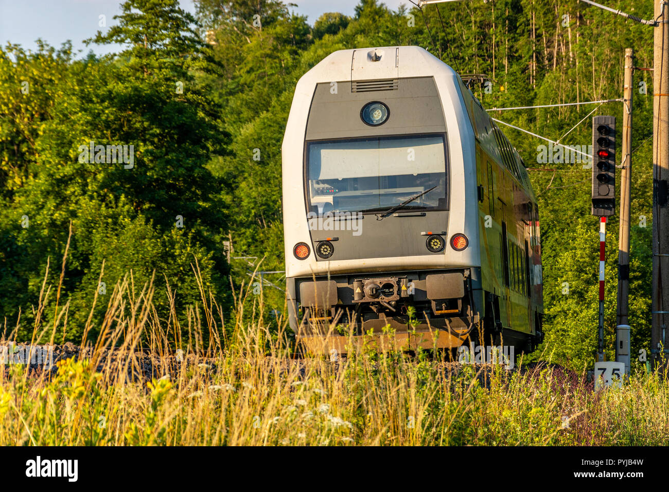 Electric locomotive passing the Czech countryside. A train running ...