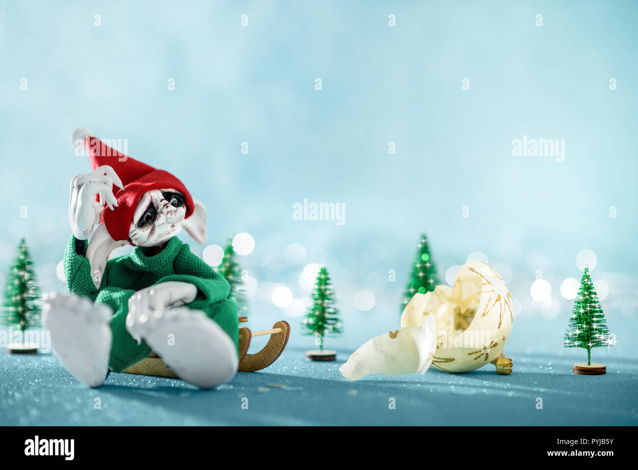 Sad Santas Helper Elf Sitting on Sledge Looking At Broken Christmas ...