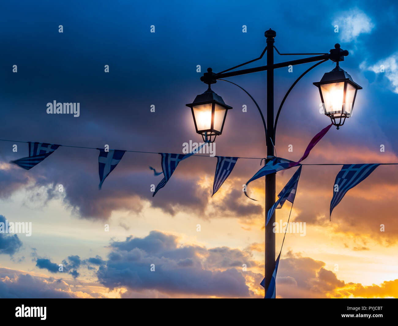 National Greek flag on beautiful sunset clouds background Stock Photo ...