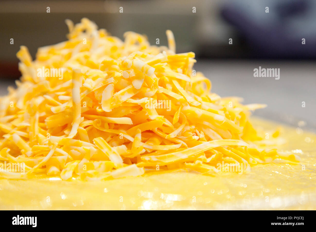 An orange pile of cheese that has been shredded, with copy space Stock ...