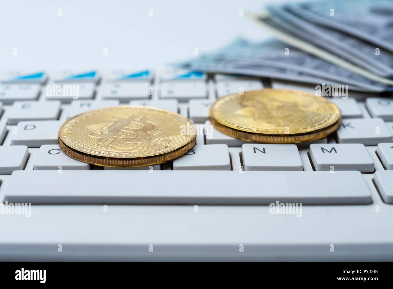 Bitcoin coin with keyboard and US dollars. Bitcoin gold coins on dollar ...