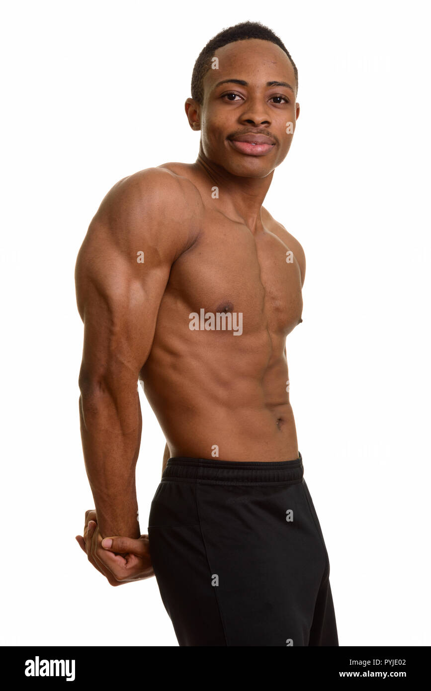 Portrait of muscular African man showing triceps muscles Stock Photo ...