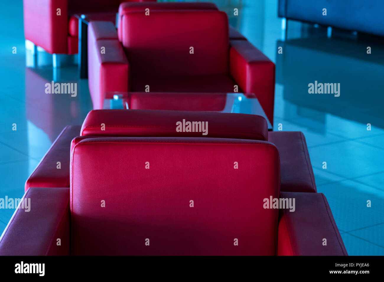 Modern red leather armchairs in the waiting area Stock Photo - Alamy
