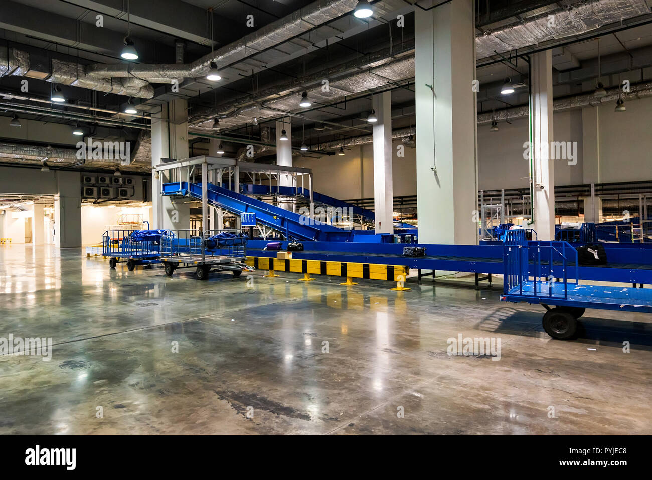 Baggage claim area with baggage carousels and carts Stock Photo - Alamy