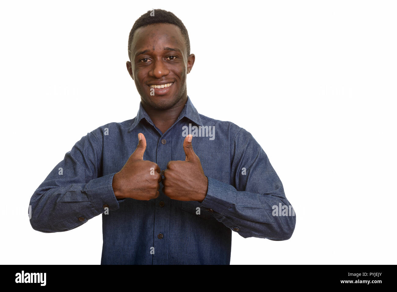 Young happy African man smiling giving thumbs up Stock Photo - Alamy