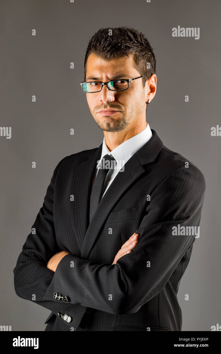 A serious man in a black suit. dark background Stock Photo - Alamy