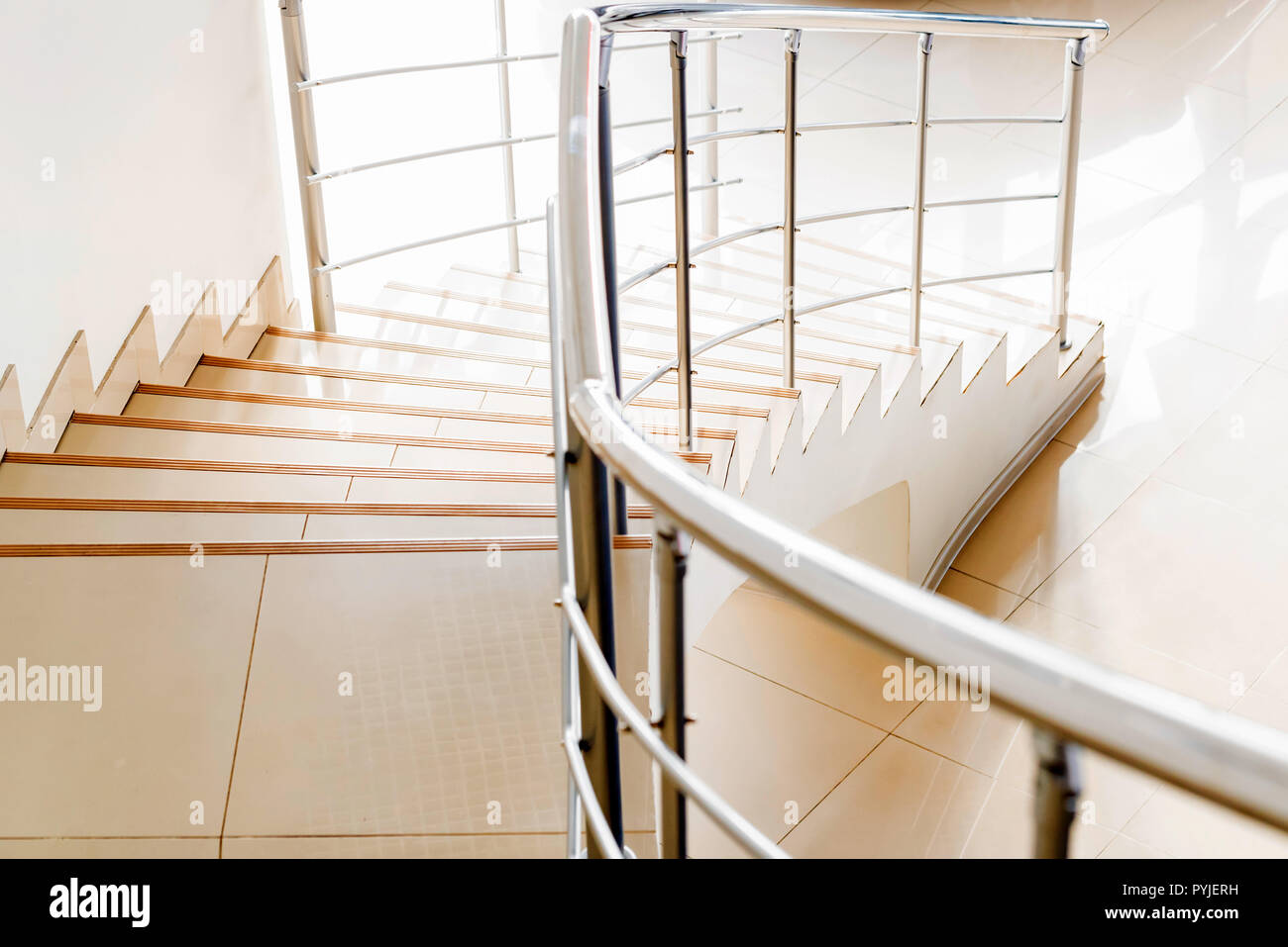 Modern beige office staircase with chrome handrails Stock Photo - Alamy