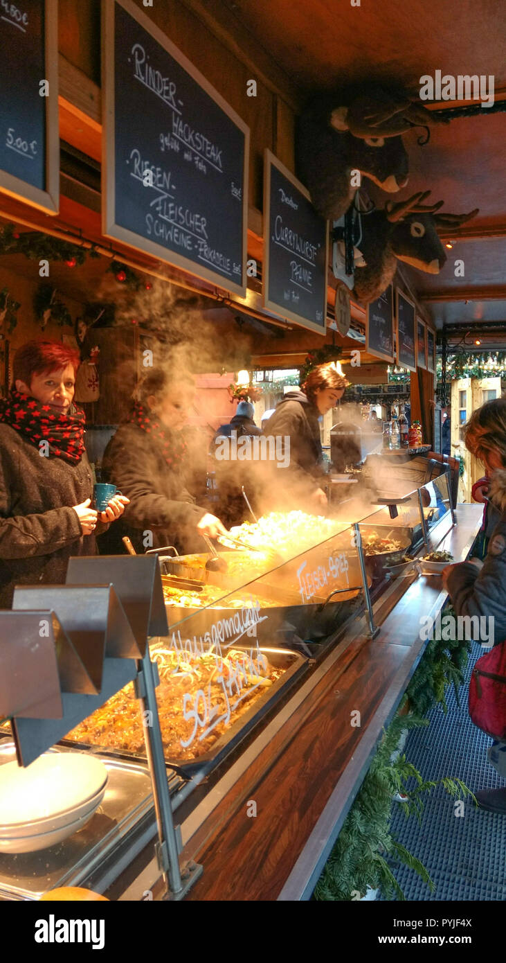 Meat and buns being prepared in a food stall on a German Christmas ...