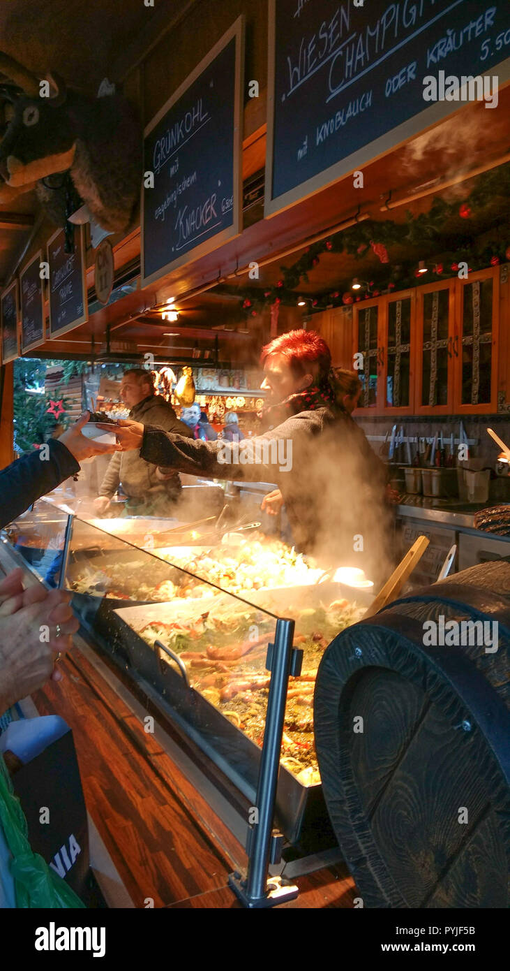 Meat and buns being prepared in a food stall on a German Christmas ...