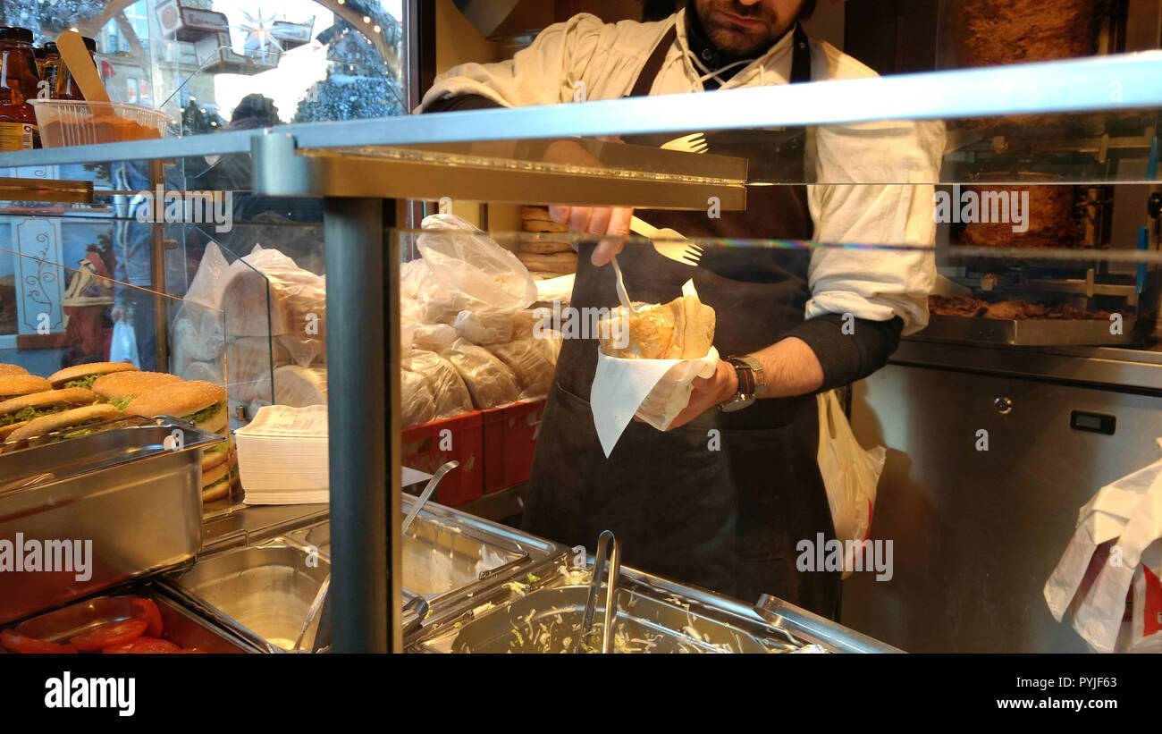 Meat and buns being prepared in a food stall on a German Christmas ...