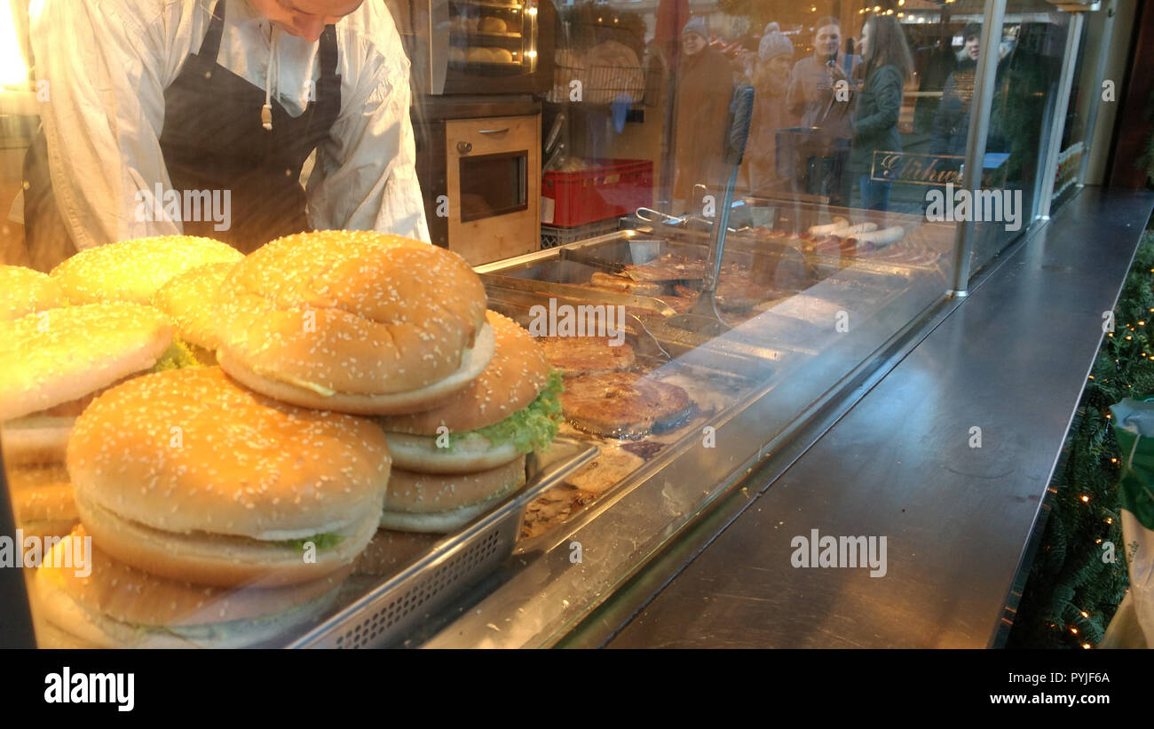 Meat and buns being prepared in a food stall on a German Christmas ...