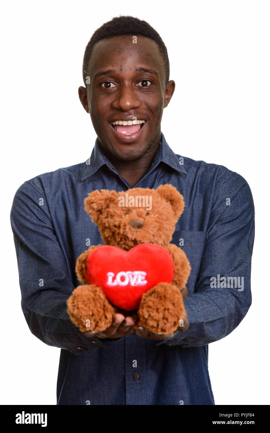 Young happy African man smiling and giving teddy bear with heart Stock ...