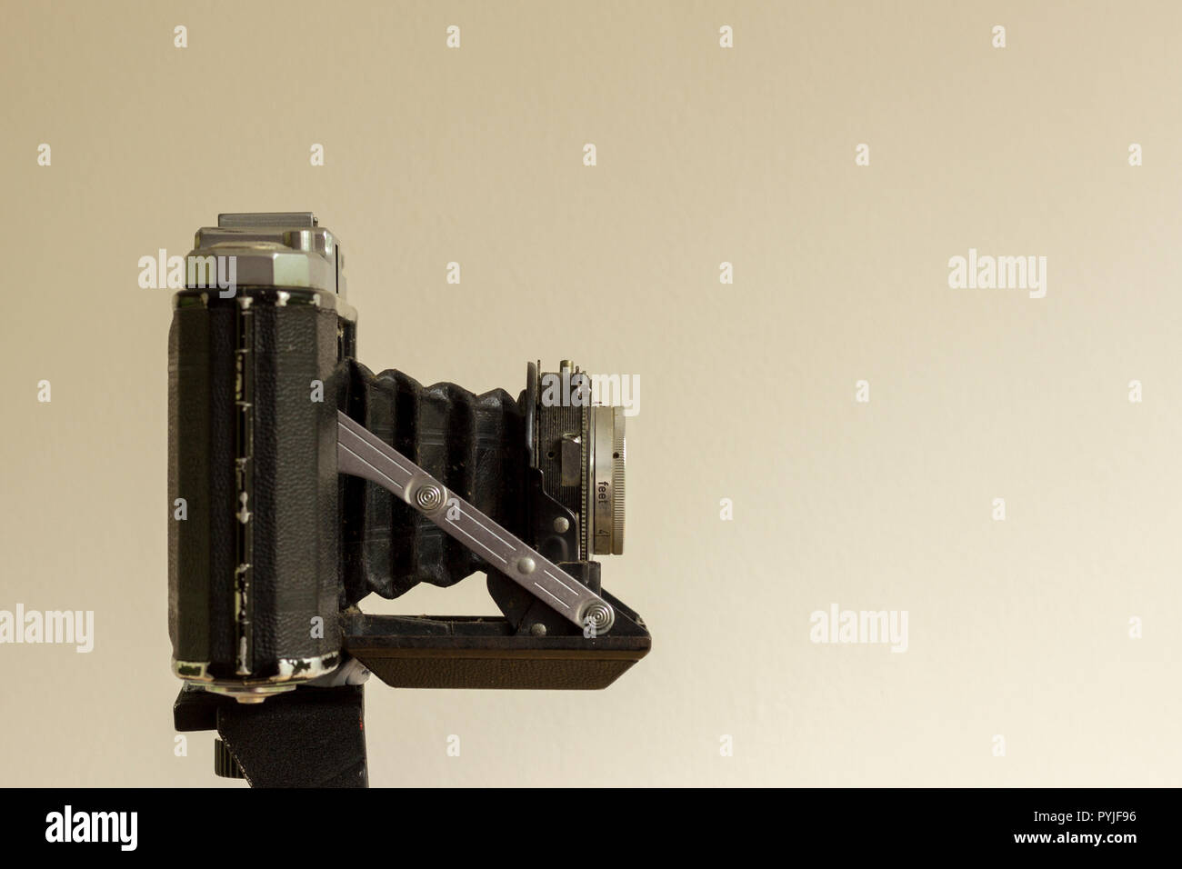 Side on view old bellows folding camera showing folding mechanism ...