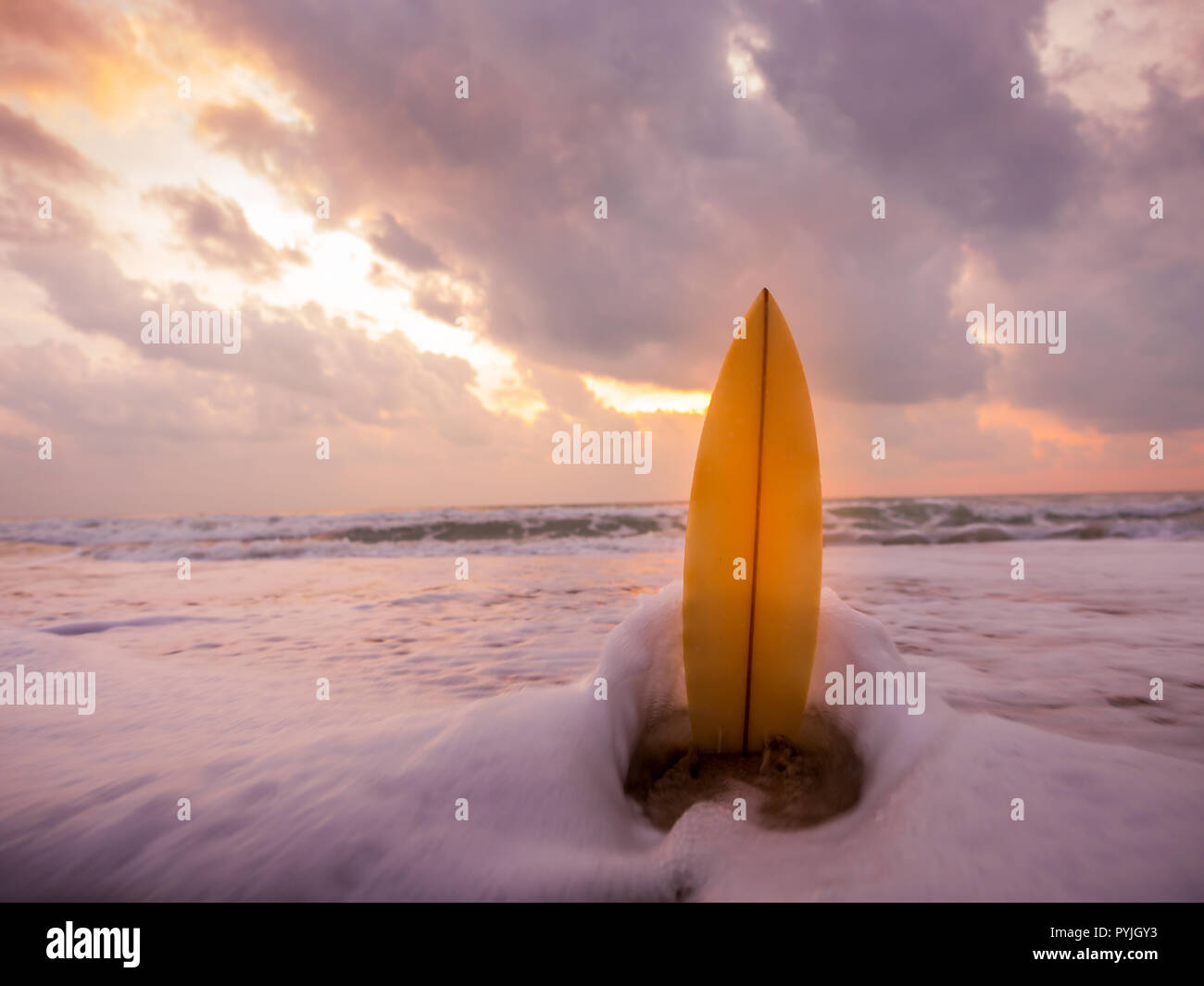 surfboard on the beach in sea shore at sunset time with beautiful light ...