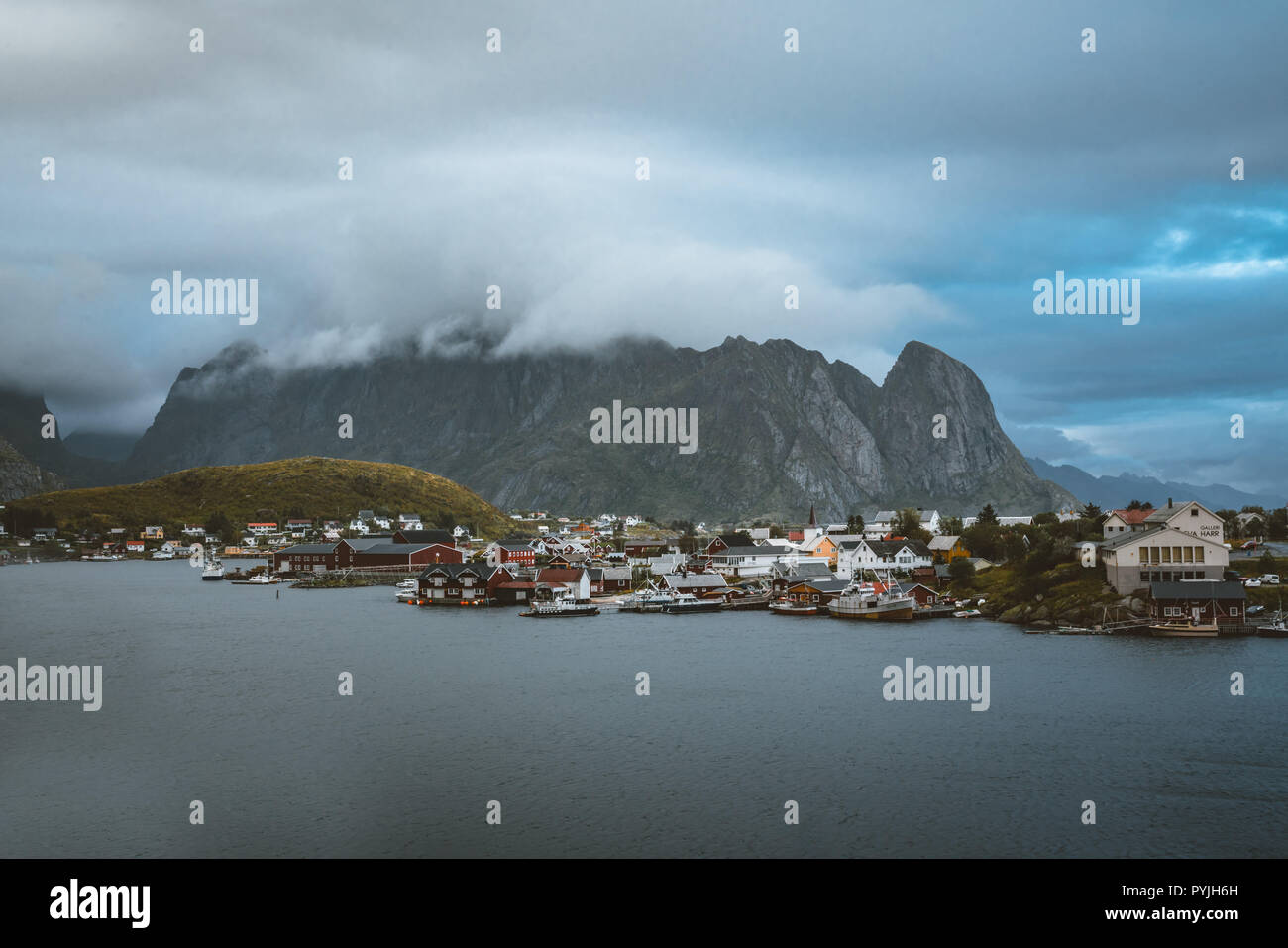 Landscape of fishing village Reine with the Reine Fjord during sunset ...