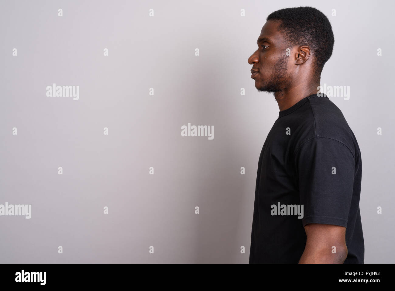 Young African man wearing black shirt against gray background Stock ...