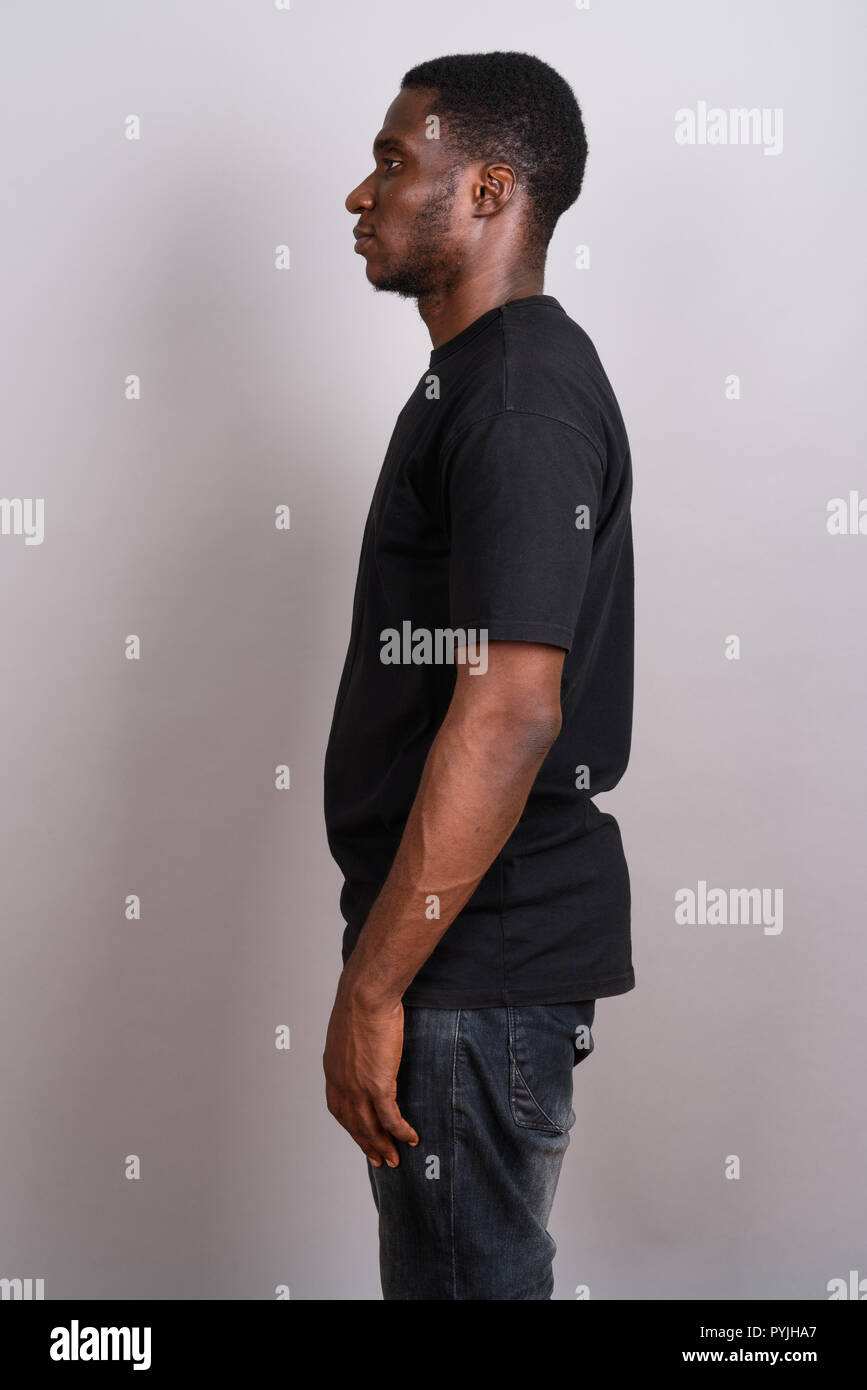 Young African man wearing black shirt against gray background Stock ...
