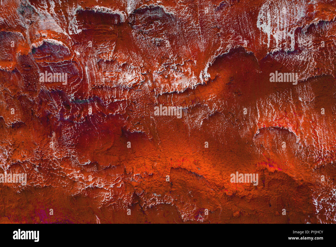 Close-up of carved stone artifact of red color. Exclusive texture ...