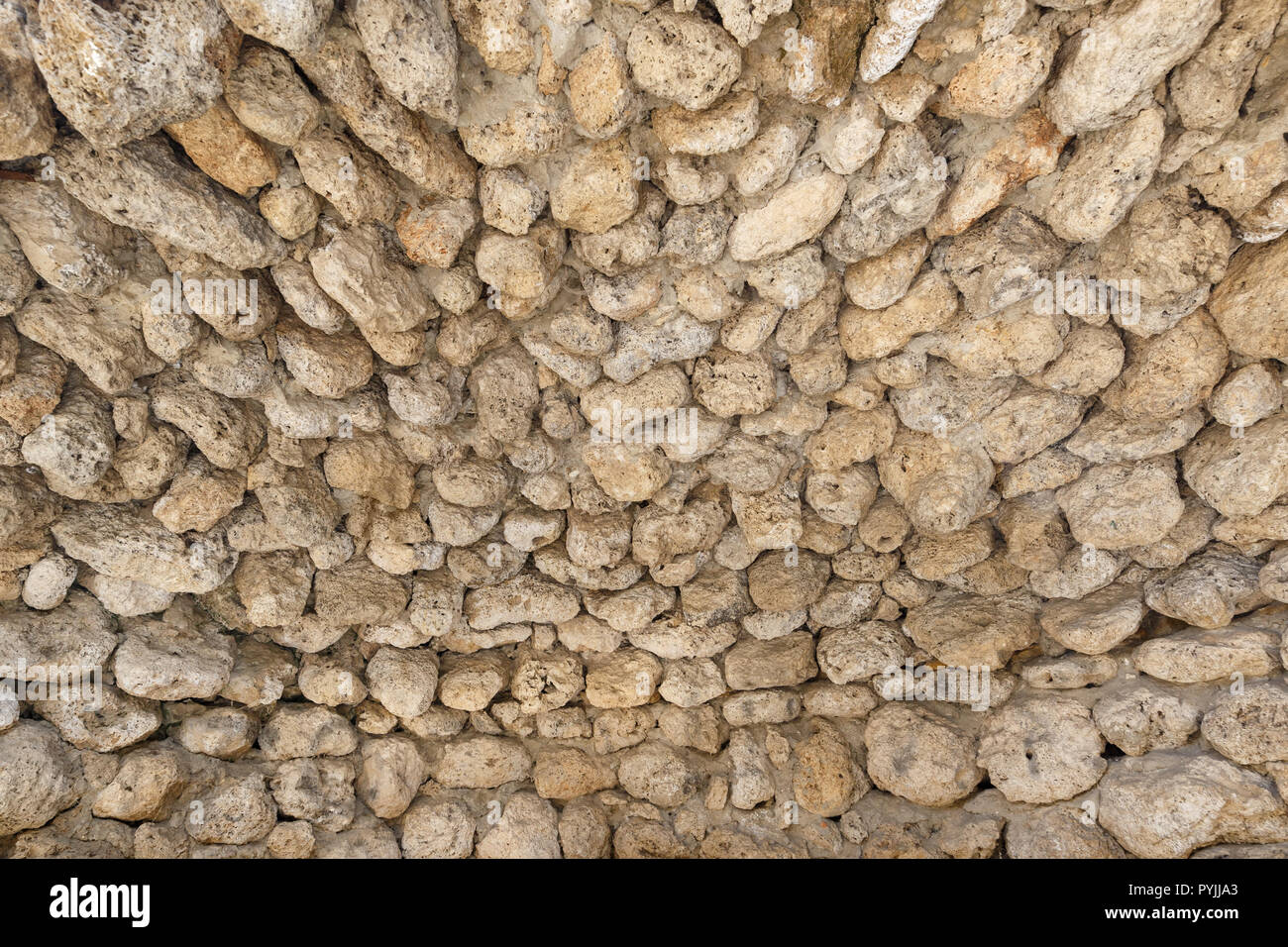 Ancient wall made of round stones as a background or backdrop Stock ...