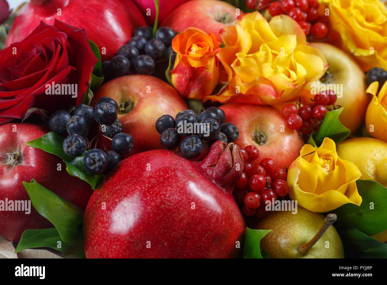 Still life consisting of pomegranates, apples, black rowan, red ...