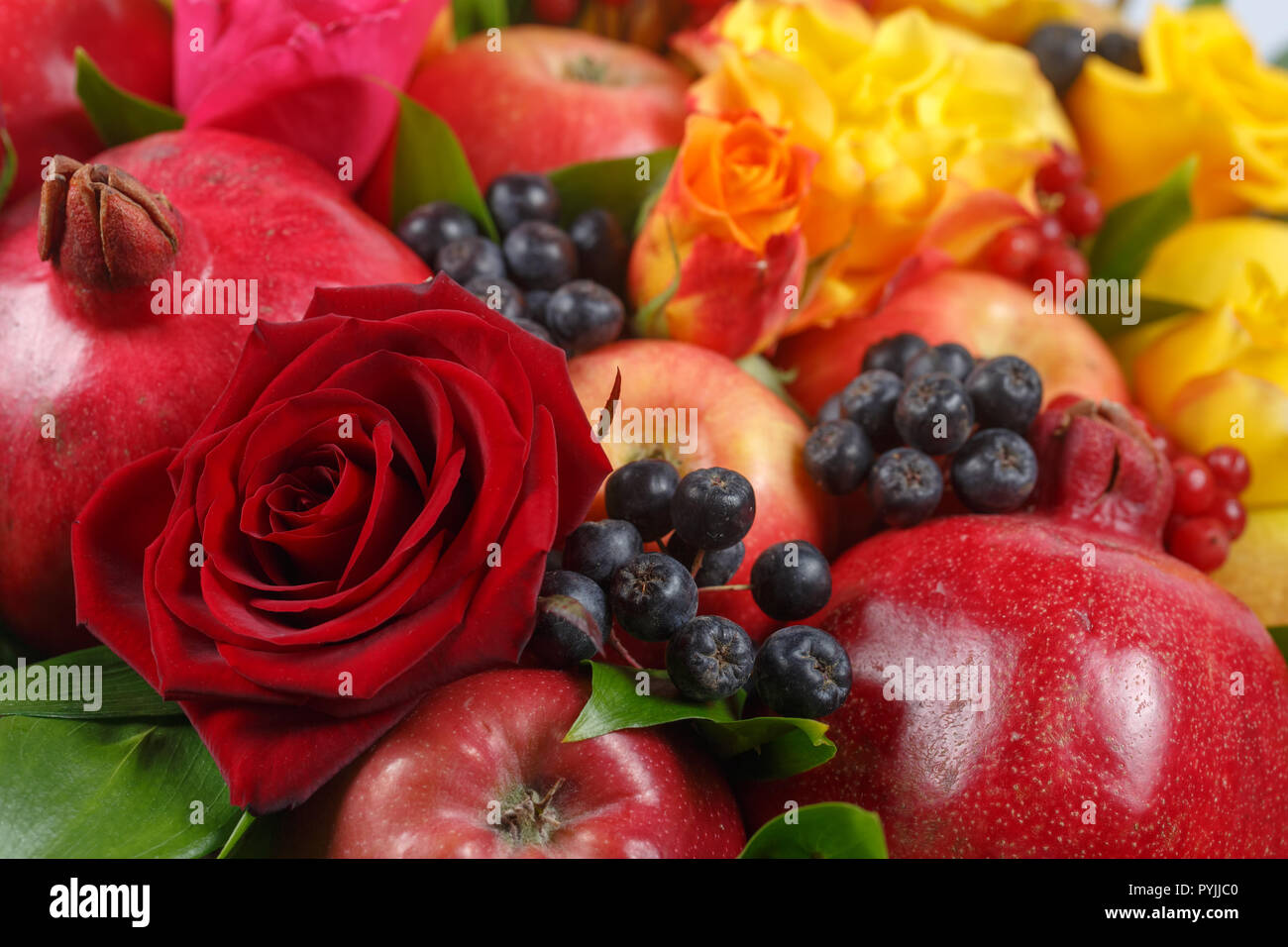 Still life consisting of pomegranates, apples, black rowan, red ...