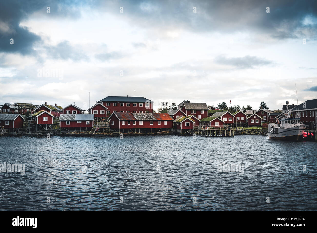 Landscape of fishing village Reine with the Reine Fjord during sunset ...