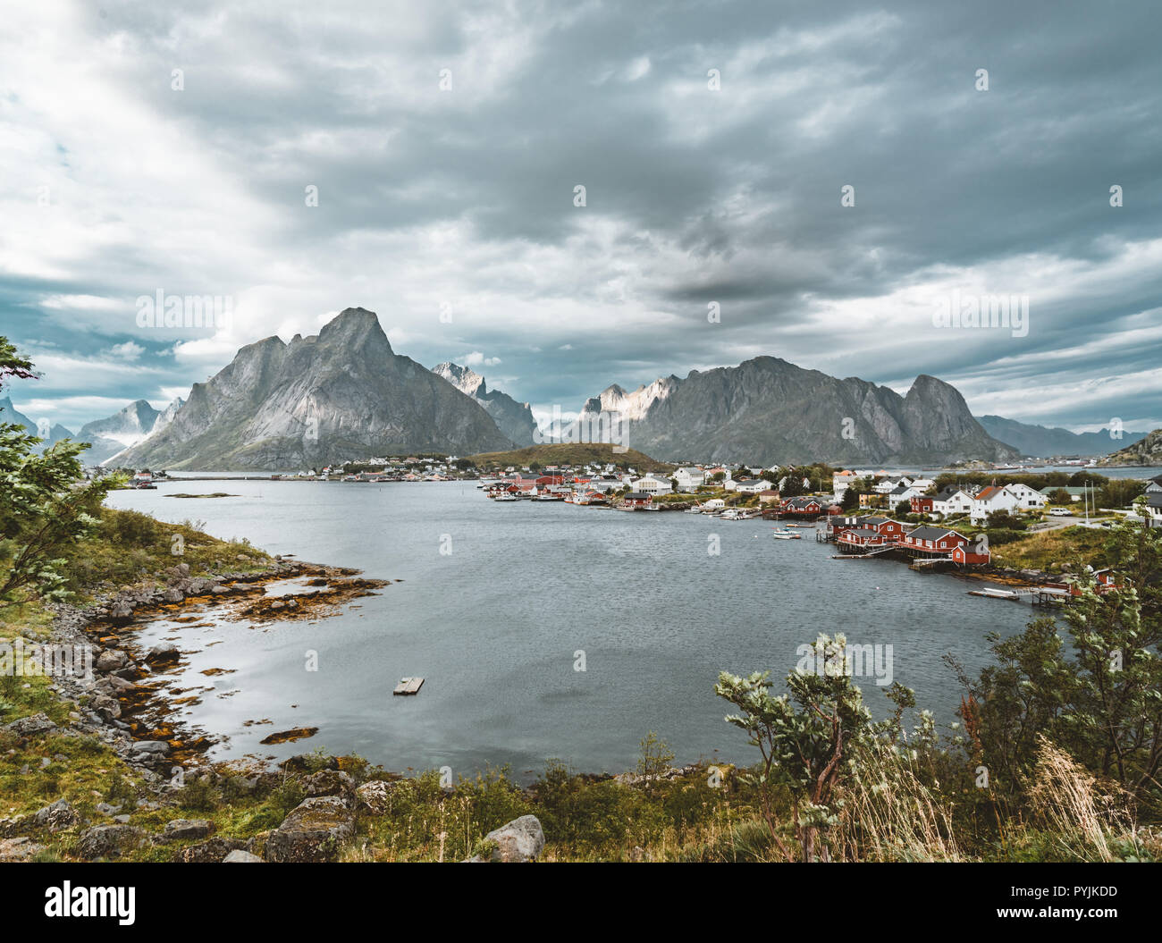 Landscape of fishing village Reine with the Reine Fjord during sunset ...