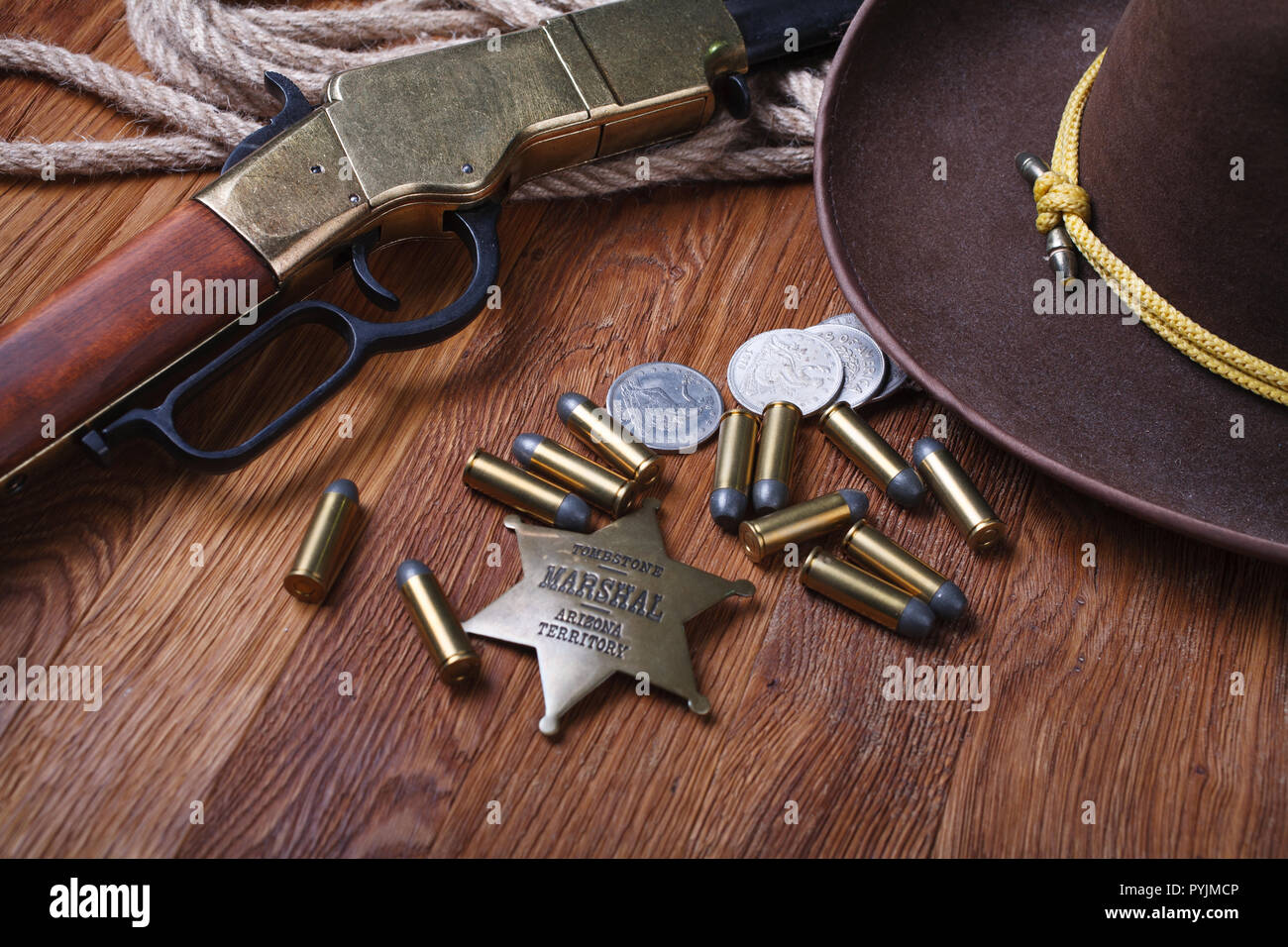 Wild west rifle, ammunition and sheriff badge on wooden table Stock ...