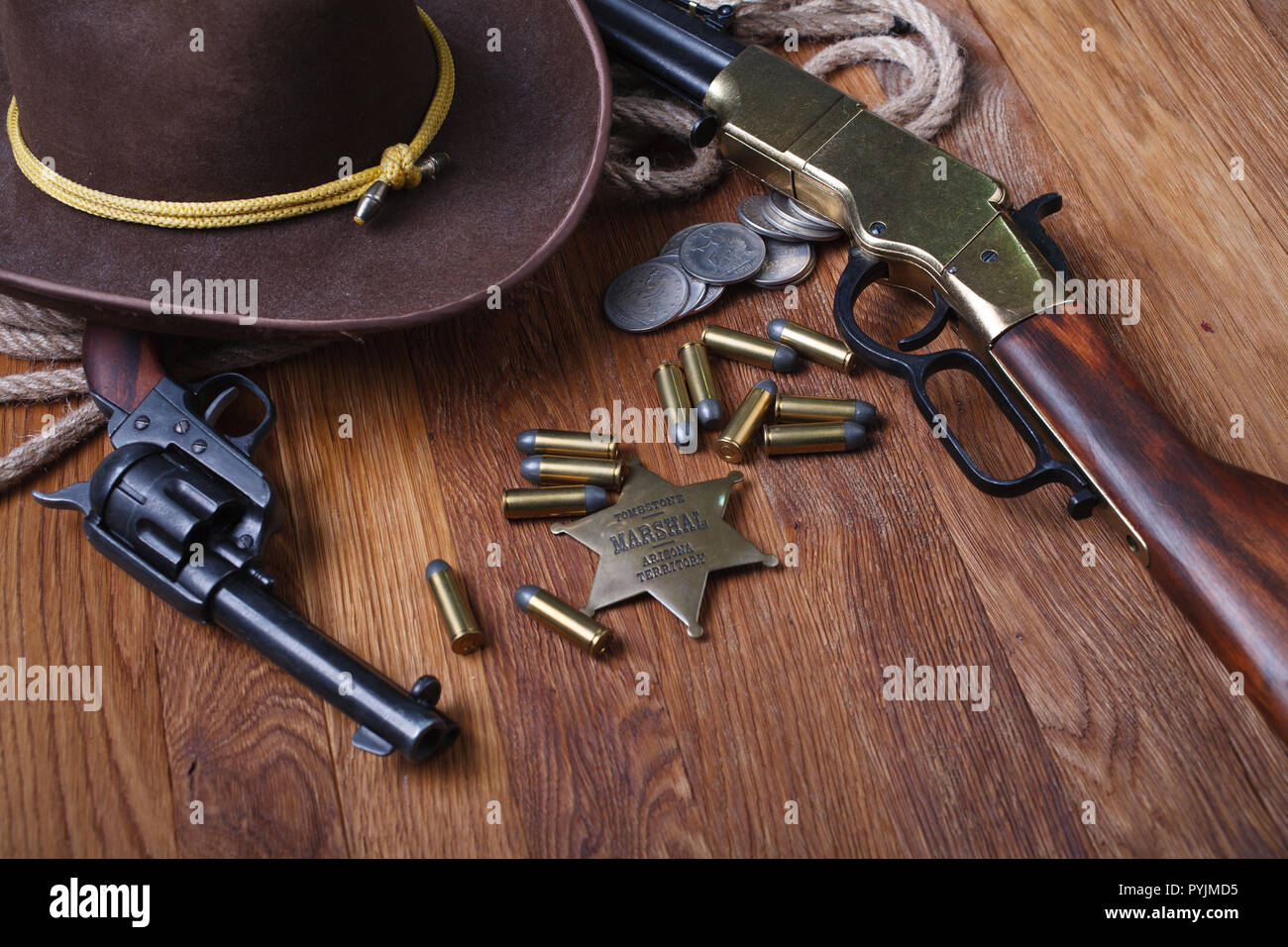 Wild west rifle, ammunition and sheriff badge on wooden table Stock ...
