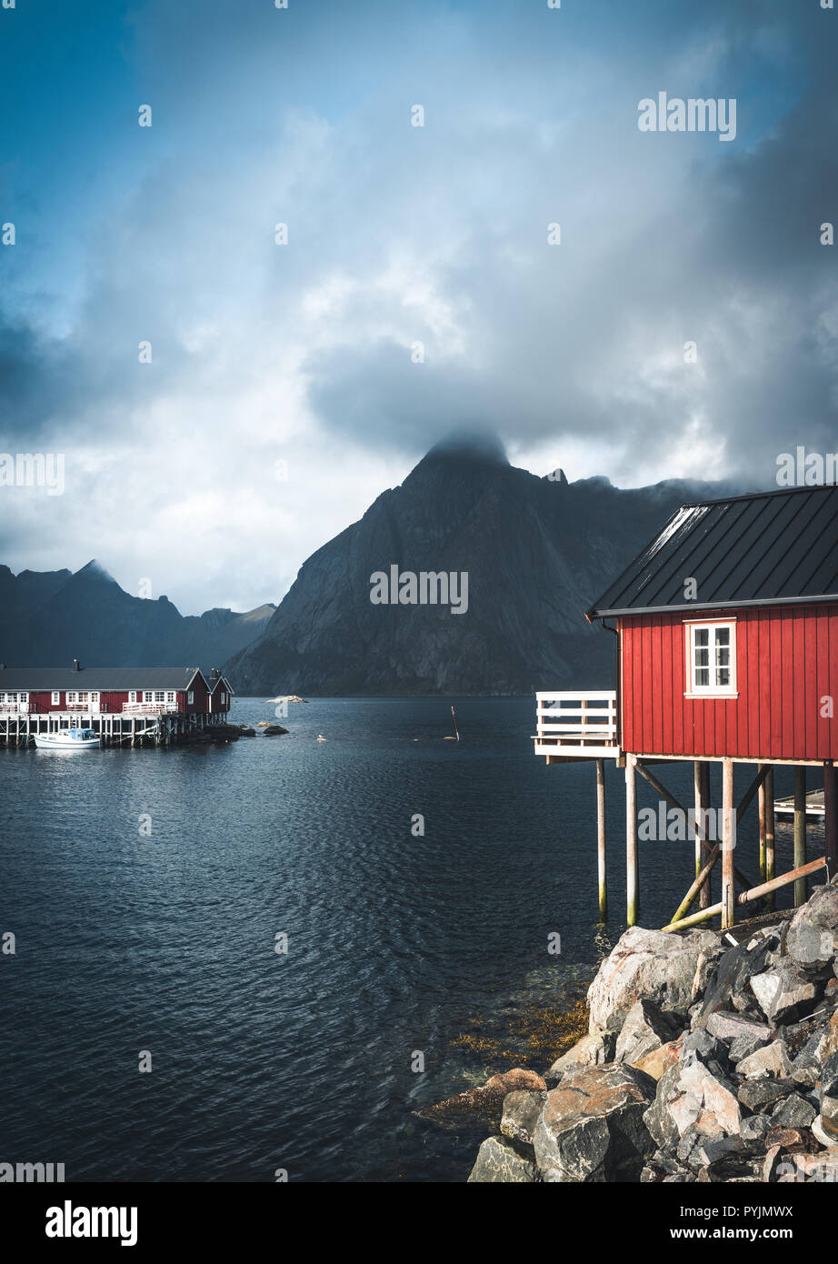 Rainbow ofer red houses rorbuer of Reine in Lofoten, Norway with red ...