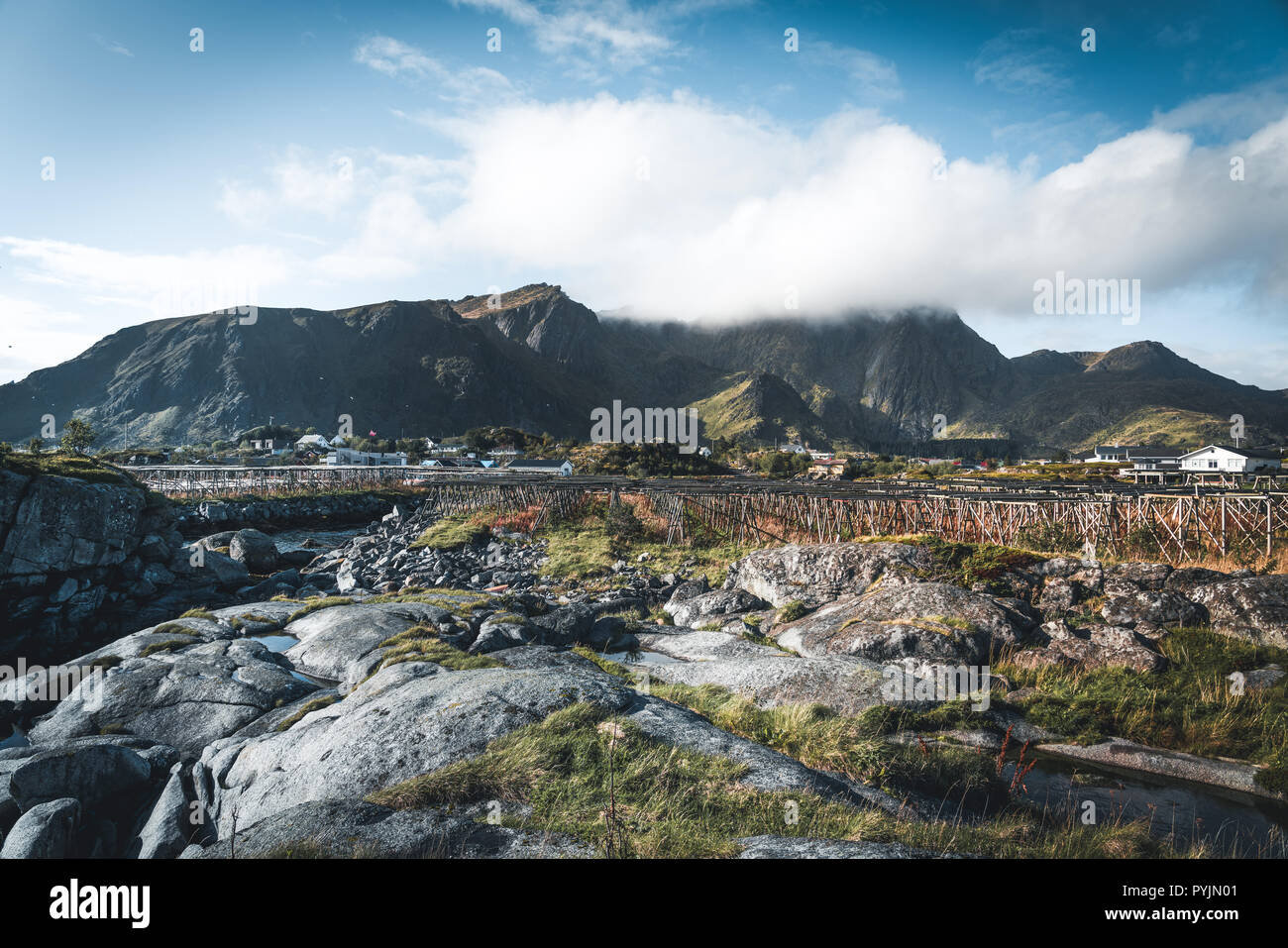 Rainbow ofer red houses rorbuer of Reine in Lofoten, Norway with red ...