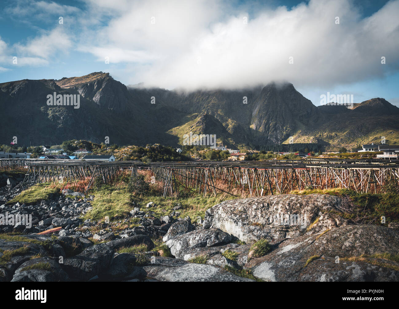 Rainbow ofer red houses rorbuer of Reine in Lofoten, Norway with red ...
