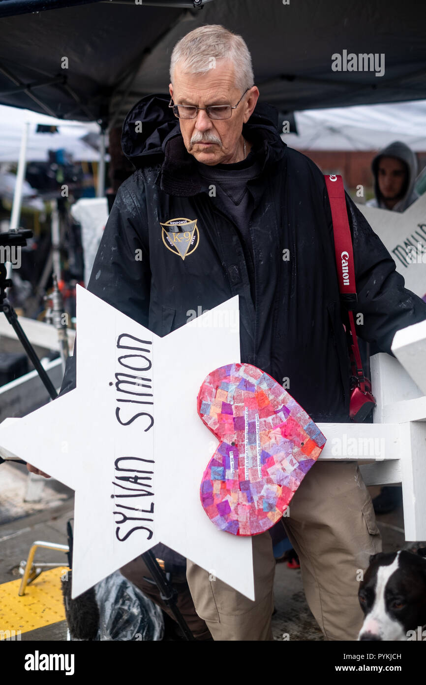 A K9 unit man seen carrying the temporary graves with the name Sylvan ...