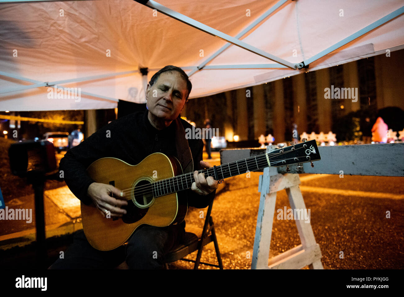 Local guitarist, Peter King, playing guitar and singing to show support ...