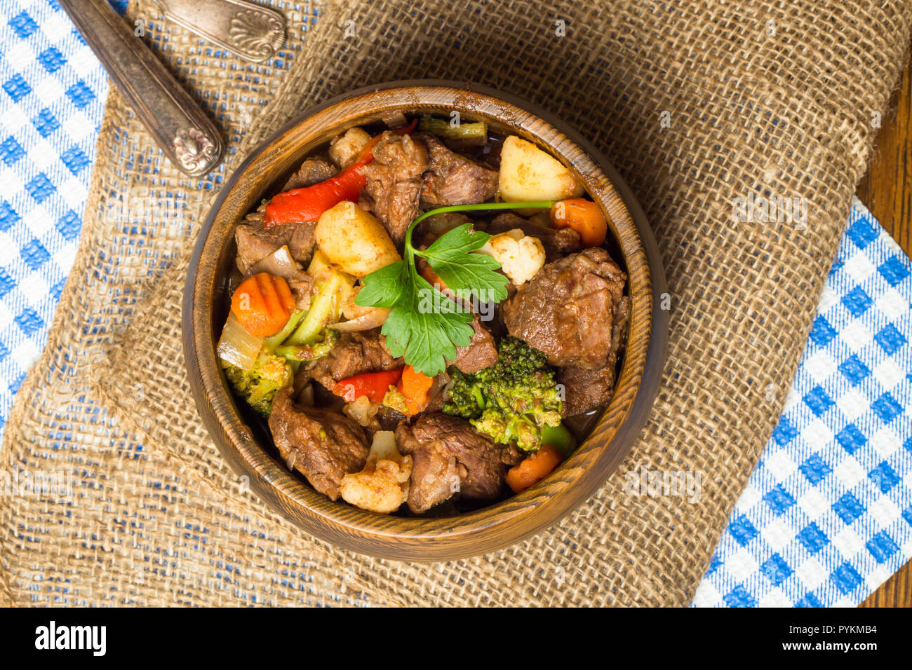 Serving of home cooked beef stew in rustic wooden bowl Stock Photo - Alamy