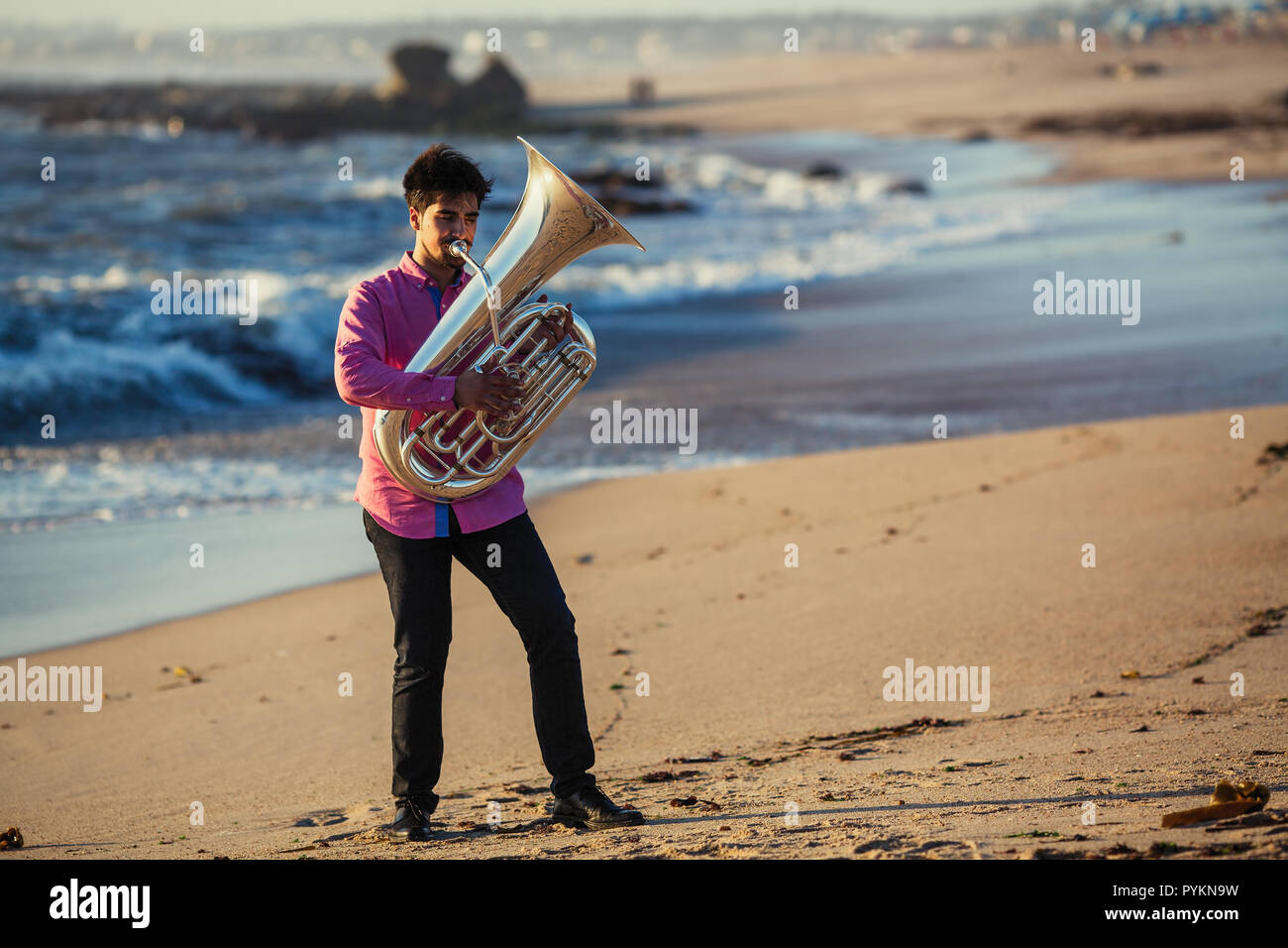 Musician play to Tuba on ocean shore Stock Photo - Alamy