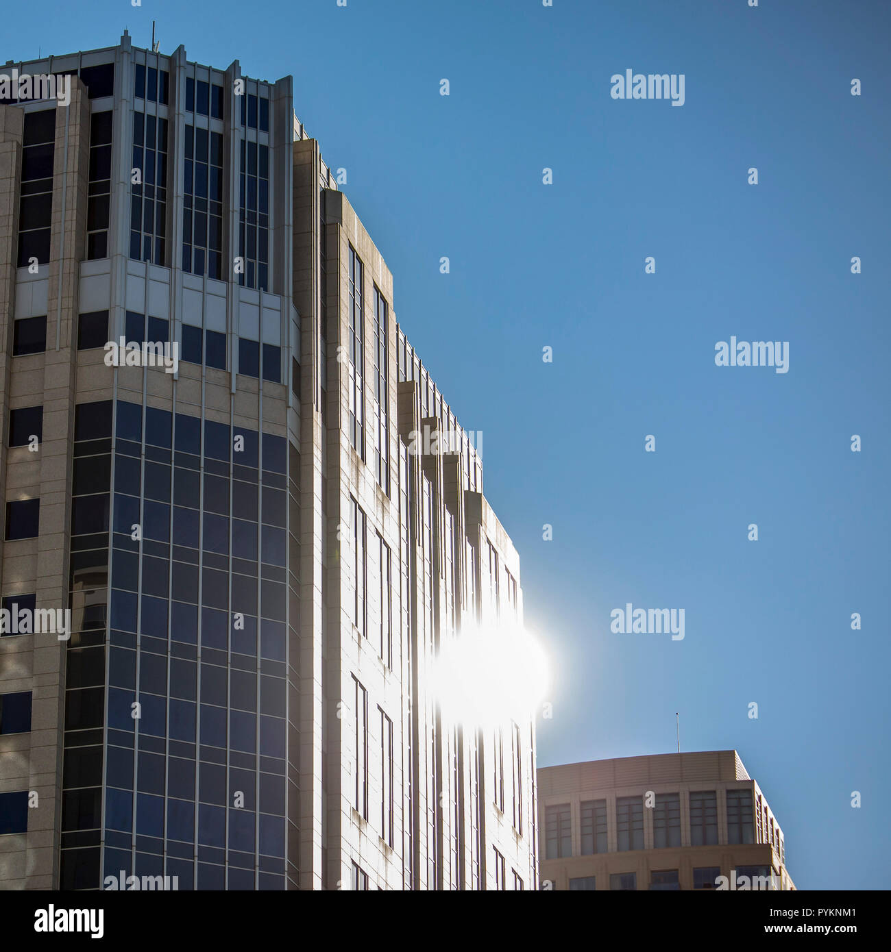 Blue glass building with reflection of the sun Stock Photo - Alamy
