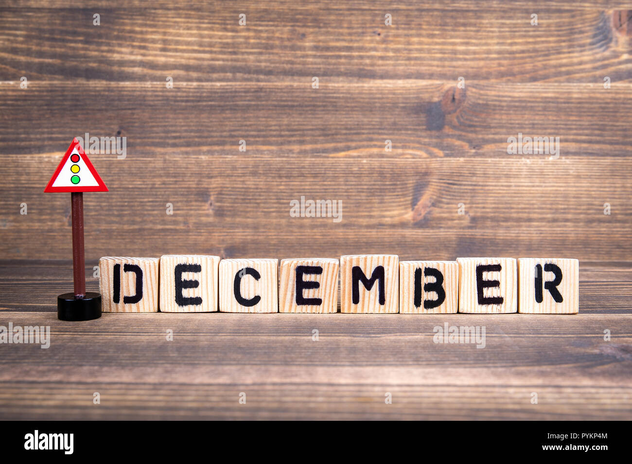 December concept. Wooden letters with road sign Stock Photo - Alamy