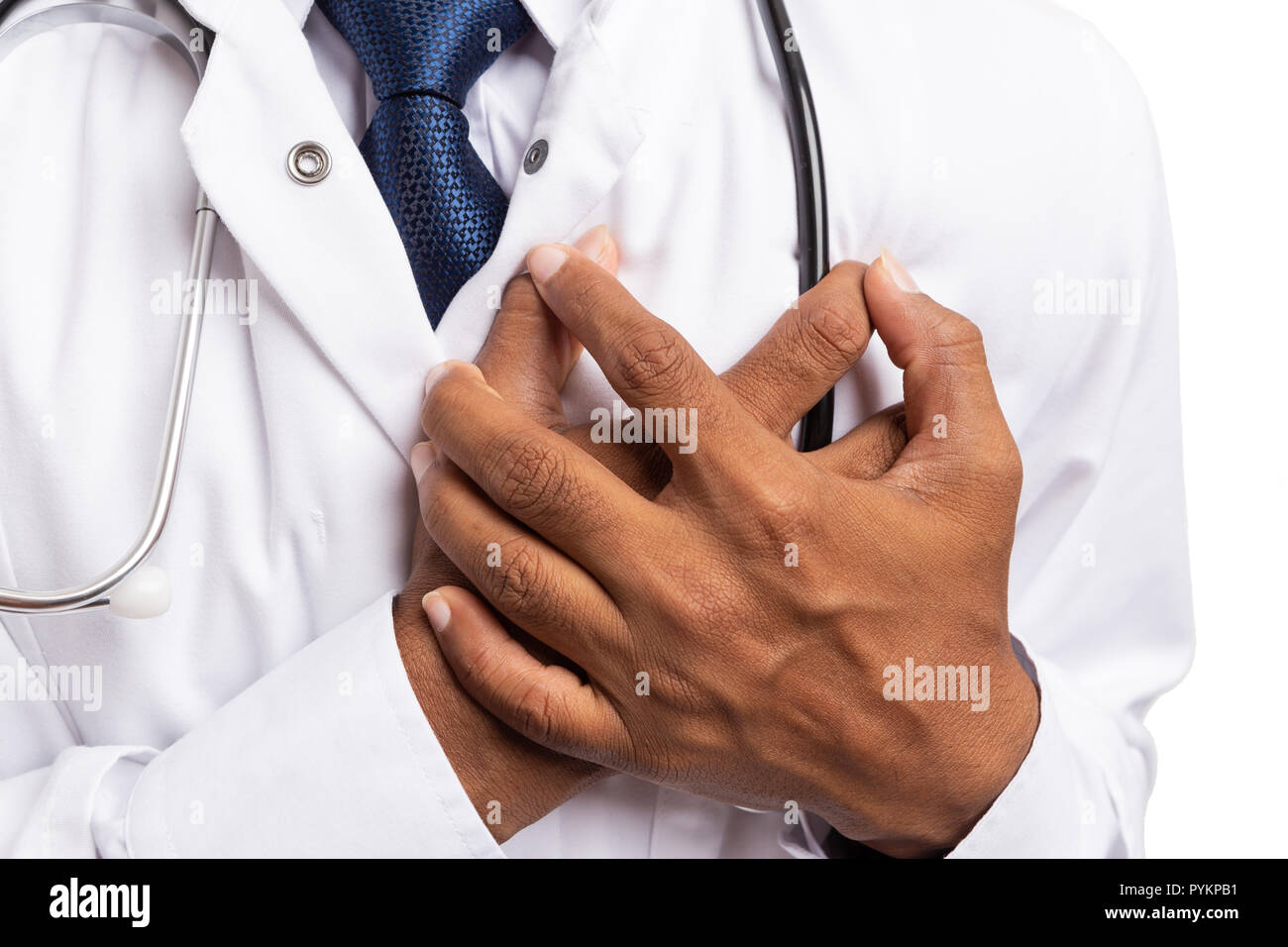 Male medic touching heart as cardiac problems concept close-up isolated ...