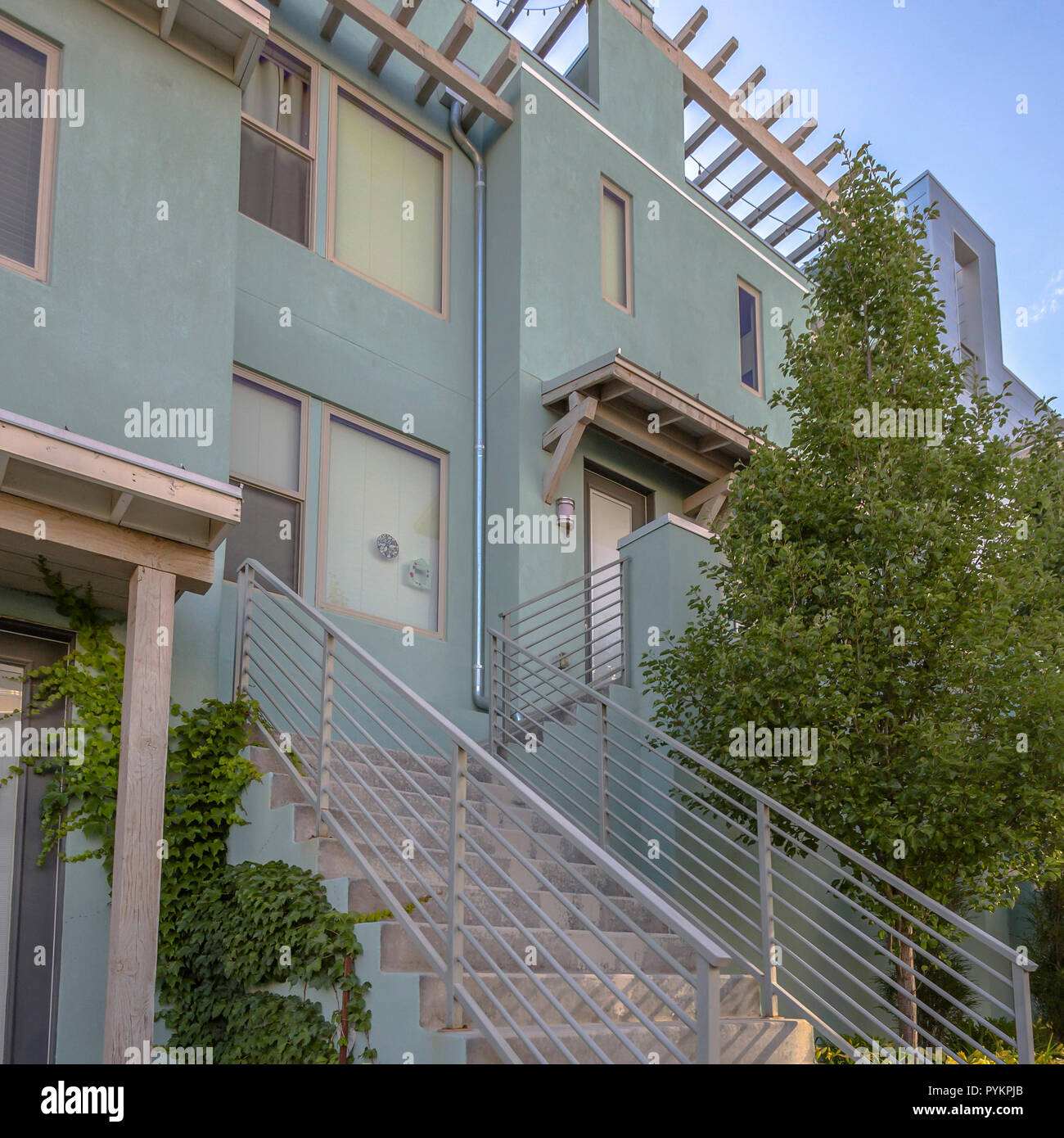 Modern home featuring stairs and flat rooftop Stock Photo - Alamy